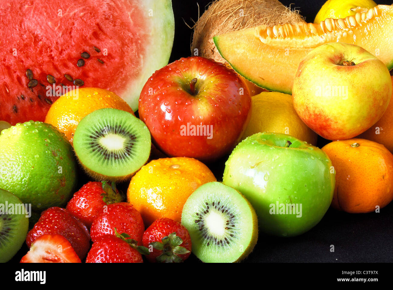 Colorful fresh fruit assortment on black background Stock Photo - Alamy