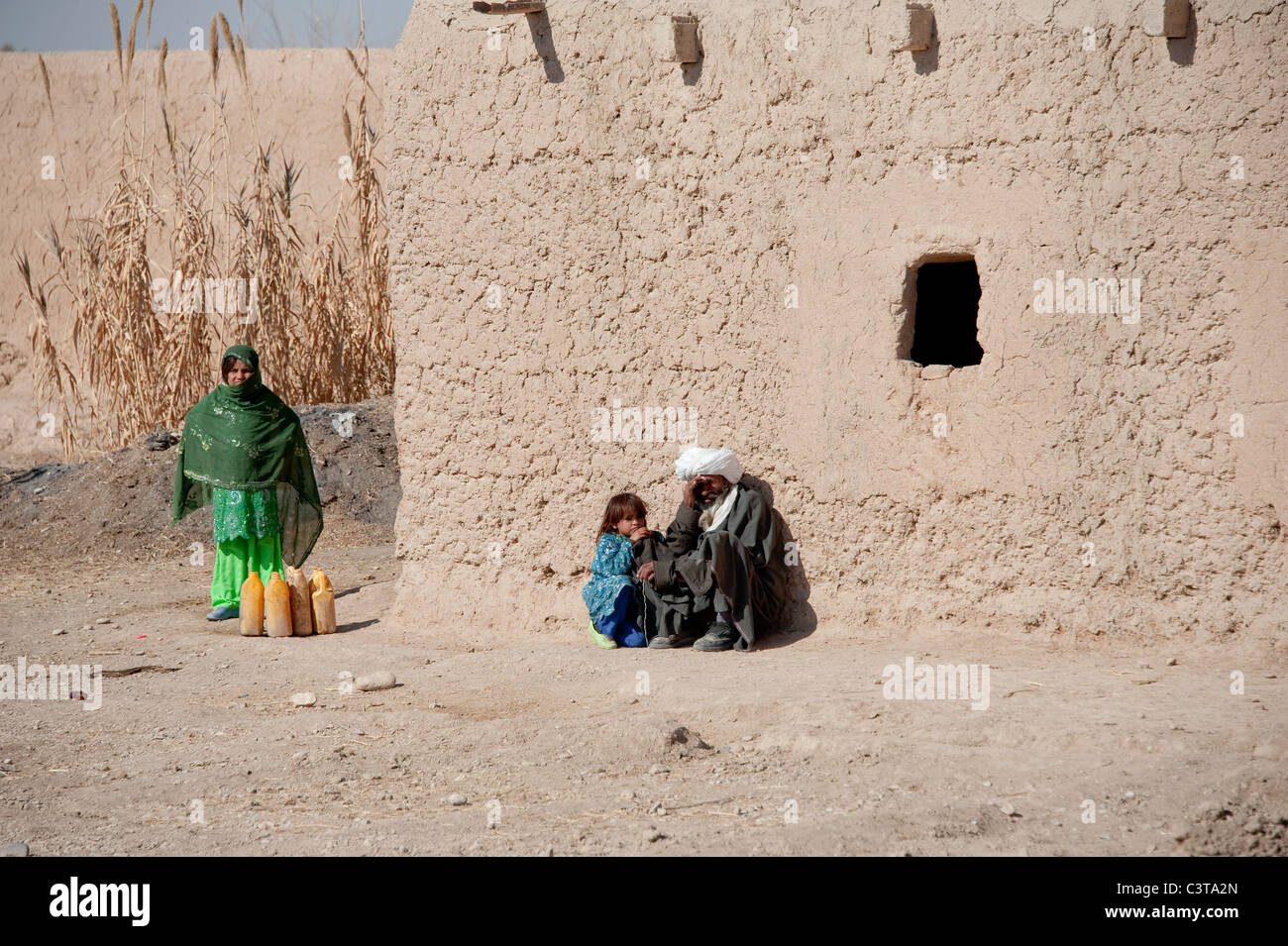 People outside traditional mud compound in Helmand Stock Photo - Alamy
