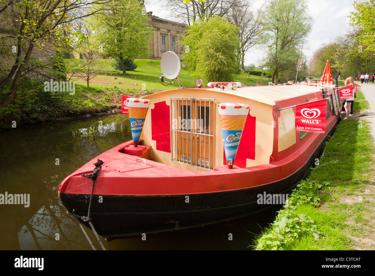 A narrow boat on the Leeds Liverpool canal at Saltaire in Yorkshire ...