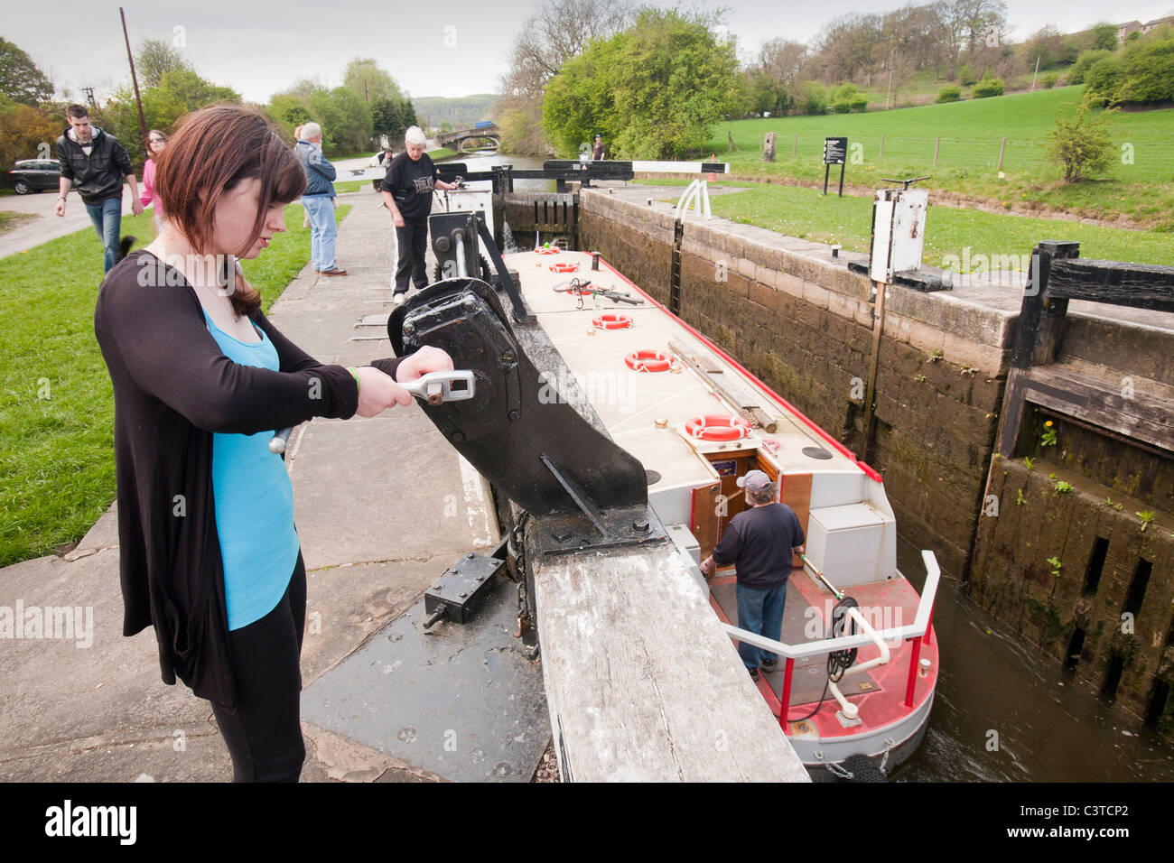A narrow boat in locks on the Leeds Liverpool canal near Saltaire in ...