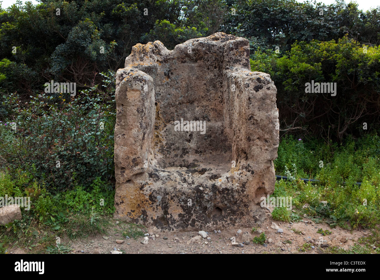 The throne carved from rock at Ancient Falassarna, Crete Stock Photo ...