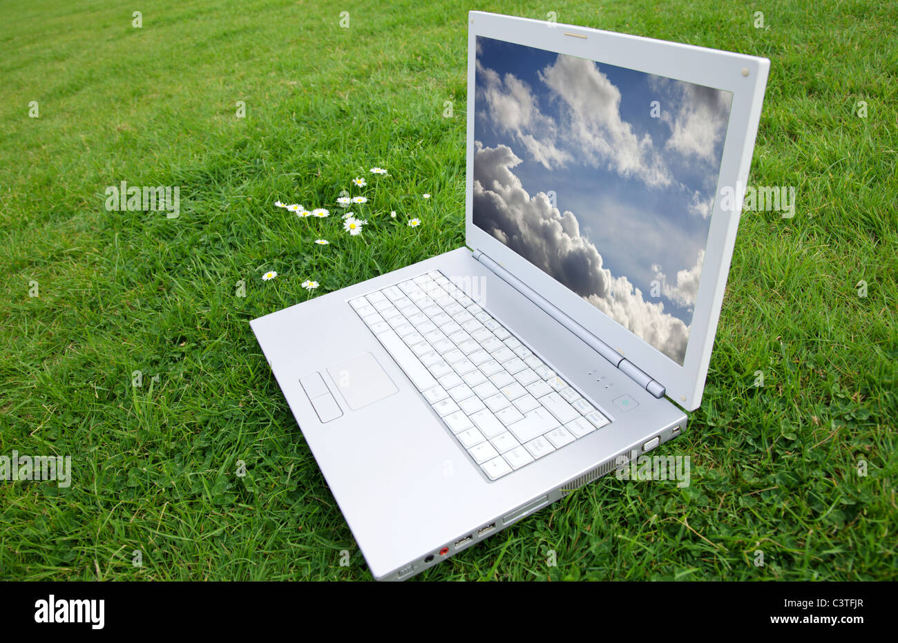 New white laptop in park with blue sky background Stock Photo - Alamy
