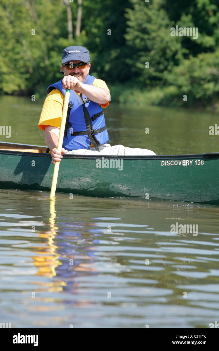 Adult man in canoes paddle on the Fox River in Yorkville Illinois USA ...