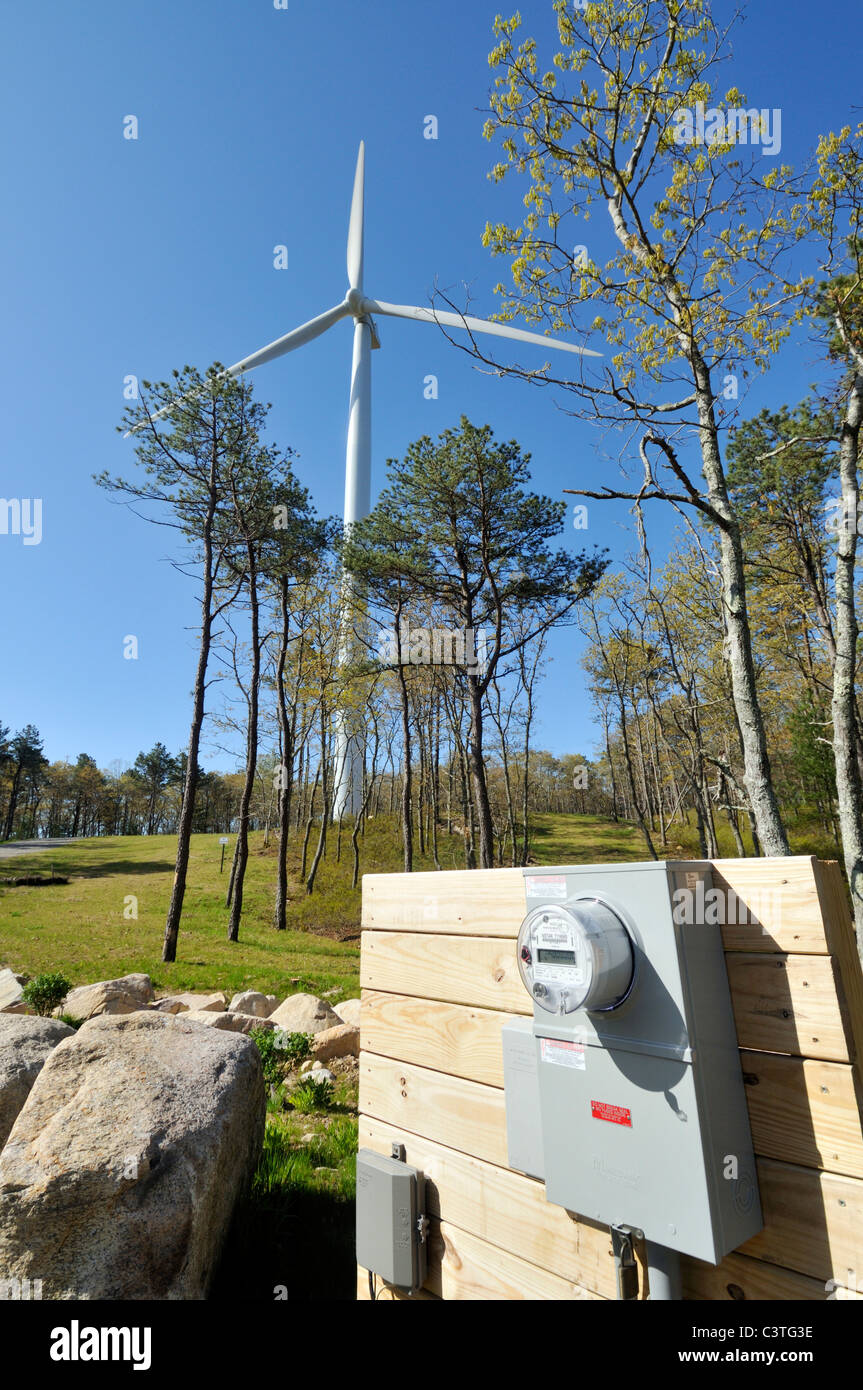 Wind turbine in the landscape with meter measuring power generated by ...