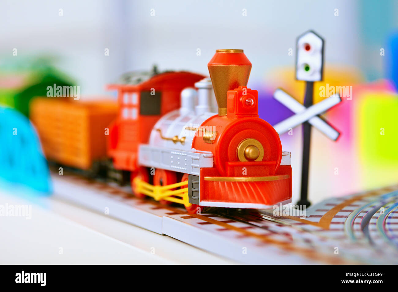 Toy miniature plastic red locomotive on railroad Stock Photo - Alamy