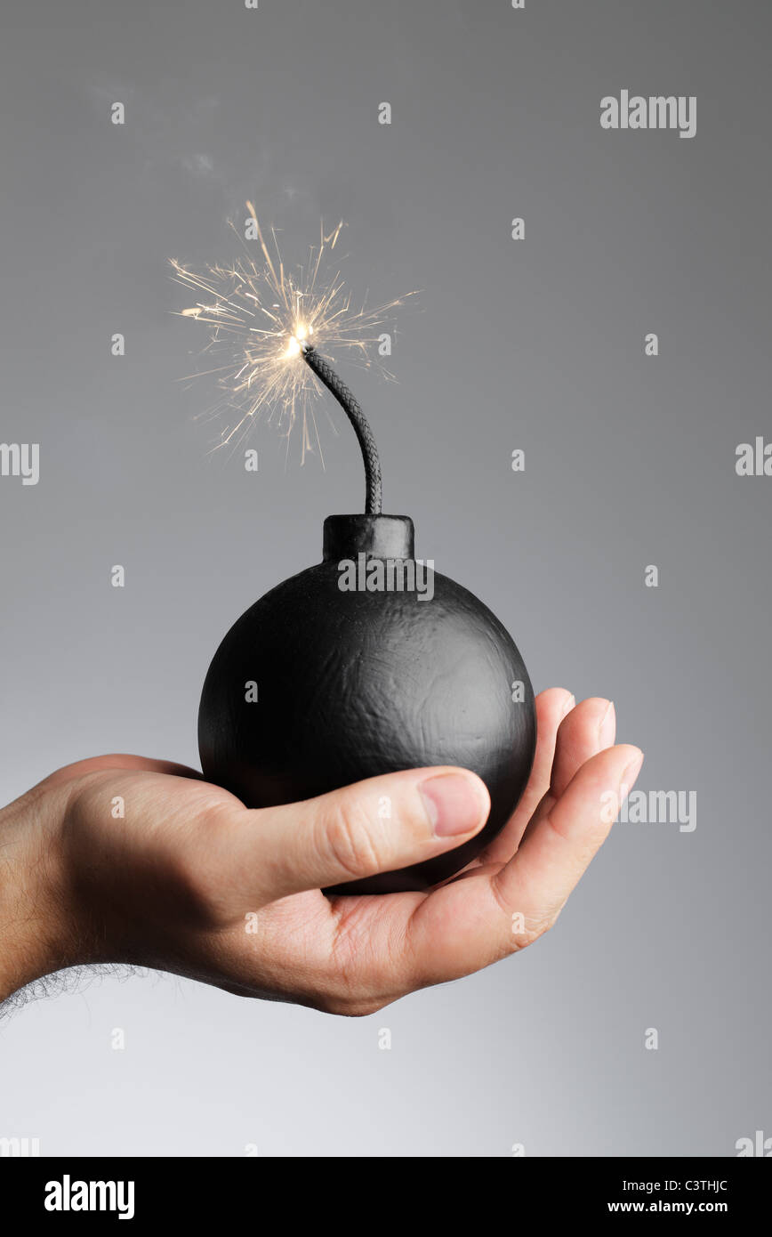 Man holding a bomb in his hand Stock Photo - Alamy