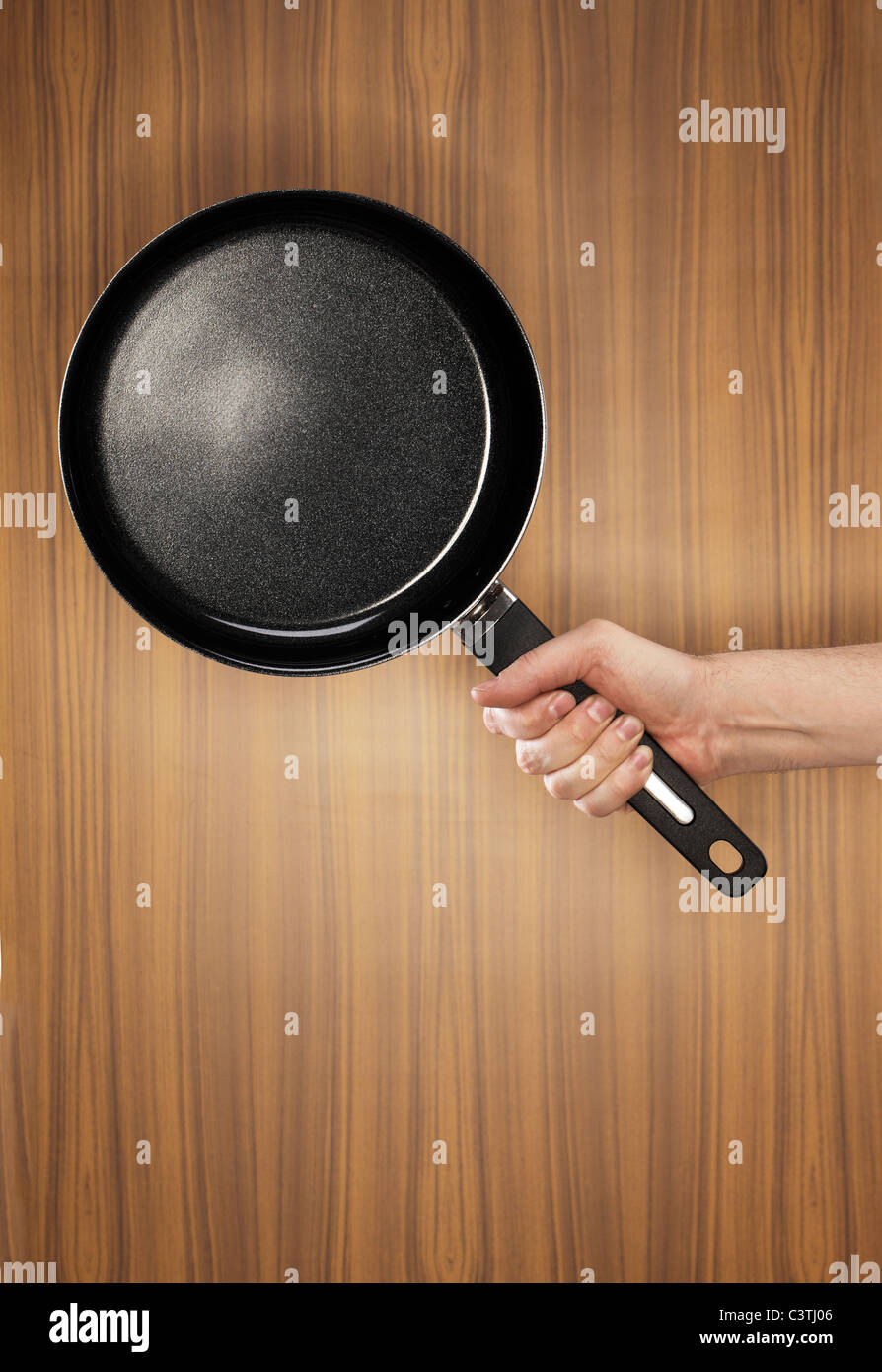 Man holding a saucepan which has a ceramic non-stick coating Stock ...