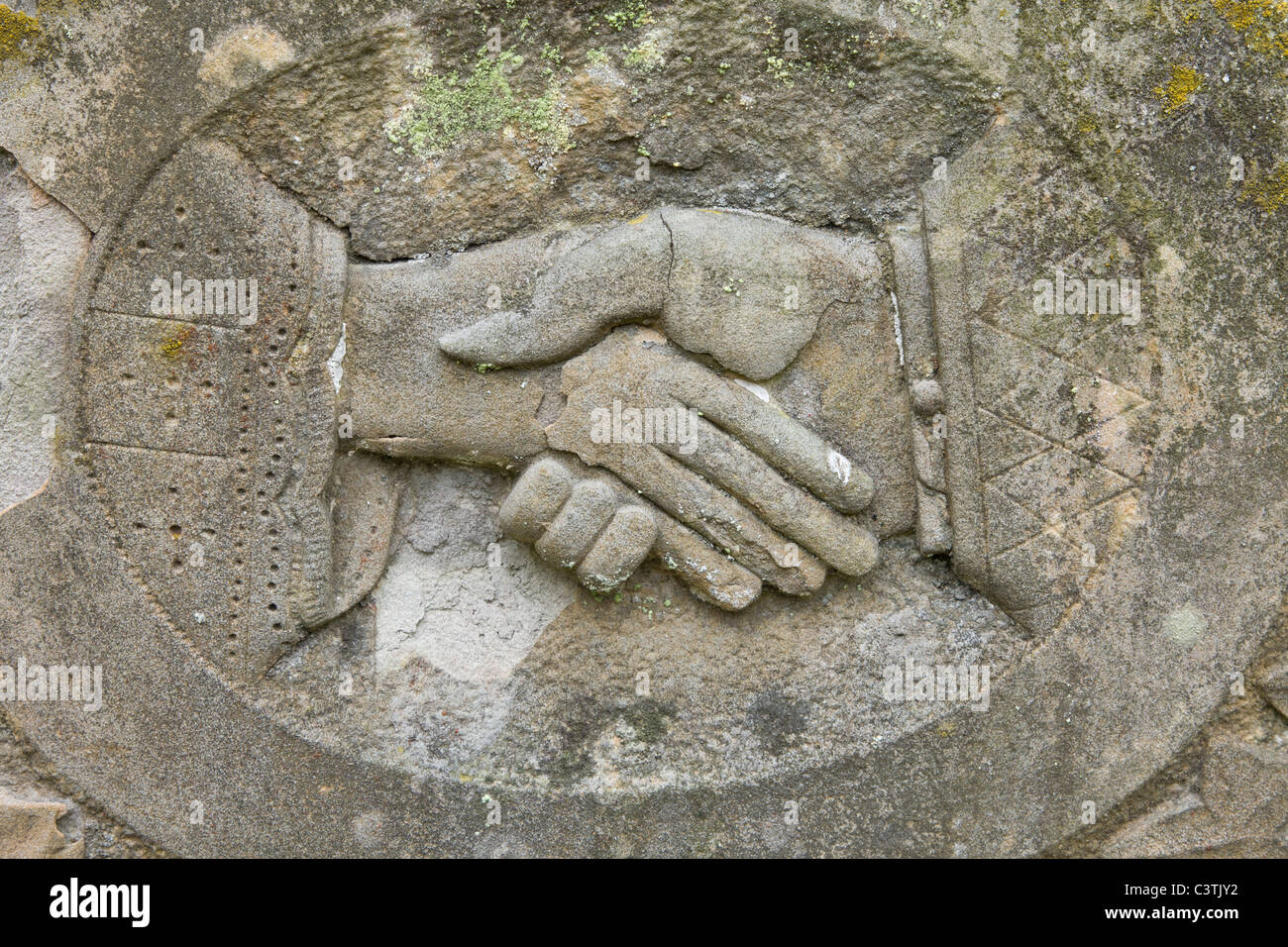 Matrimonial symbol of a handshake on a gravestone. Norfolk, England, UK ...
