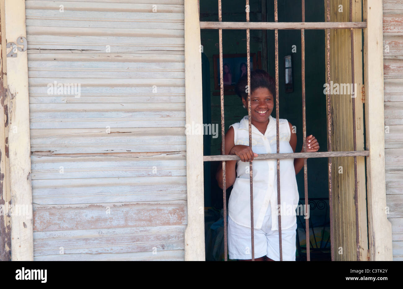 Young woman behind window bars in Cienfuegos Cuba Stock Photo - Alamy