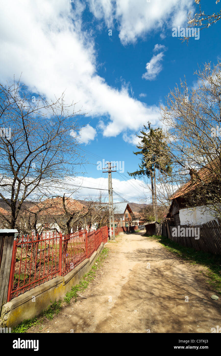 Countryside road going among rural houses Stock Photo - Alamy