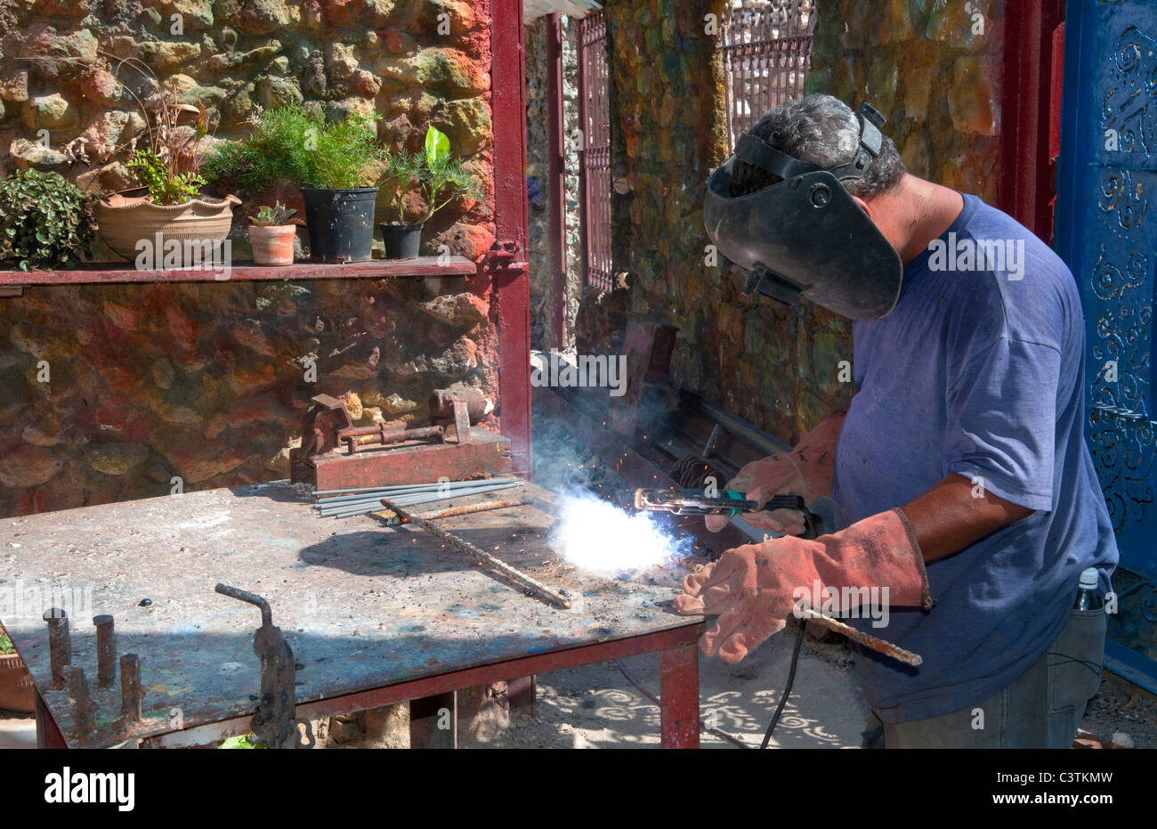 Welder artist working in very colorful wild artist area street called ...