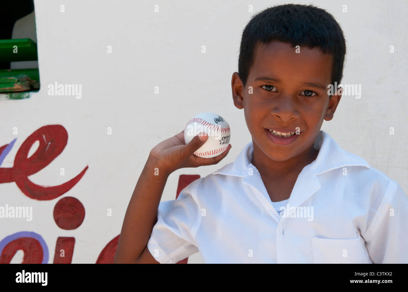 Portrait of young Cuban boy in Habvana Cuba with gift new baseball and ...