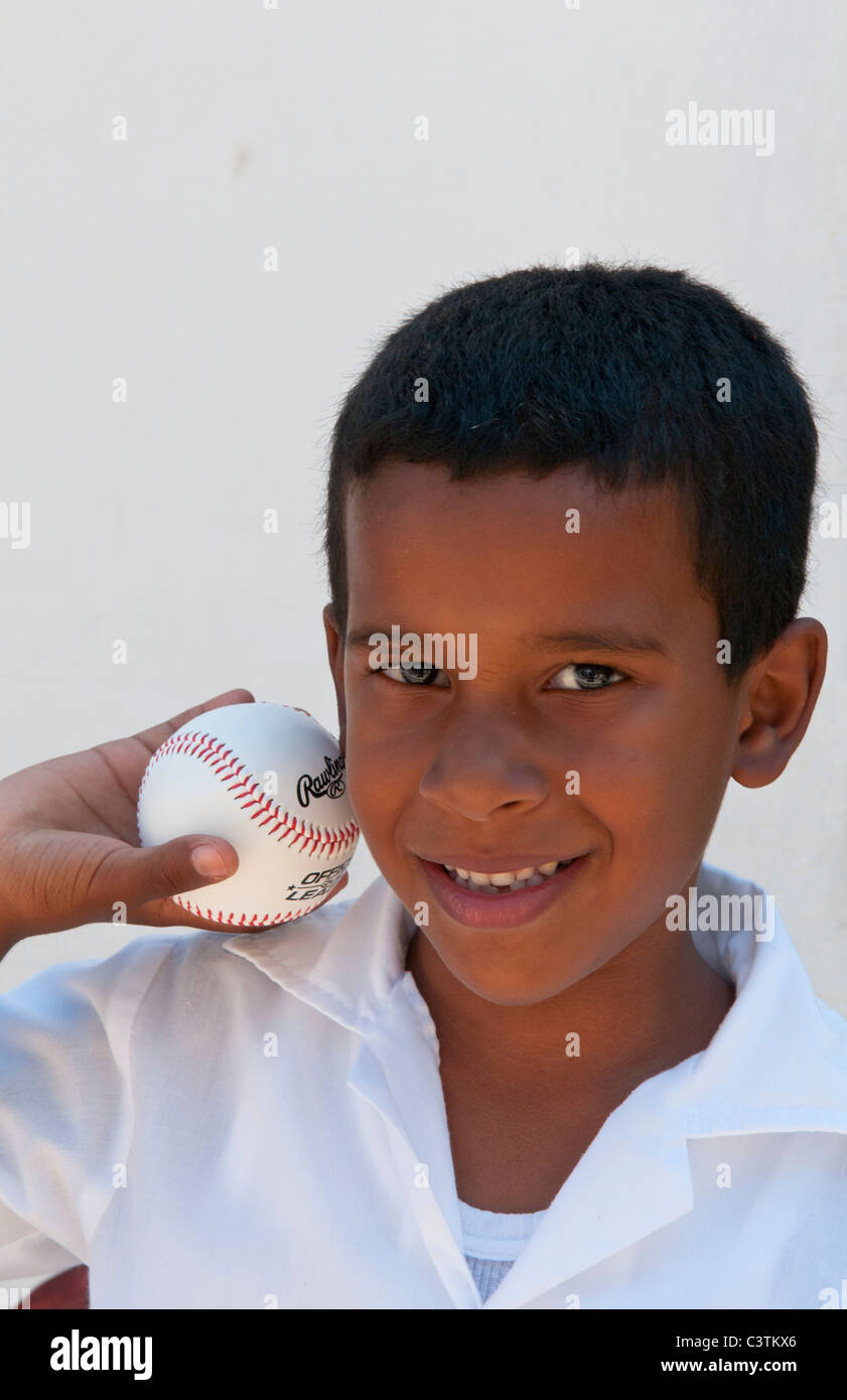 Portrait of young Cuban boy in Habvana Cuba with gift new baseball and ...