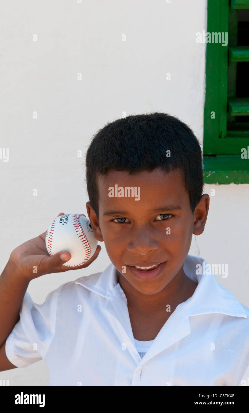Portrait of young Cuban boy in Habvana Cuba with gift new baseball and ...