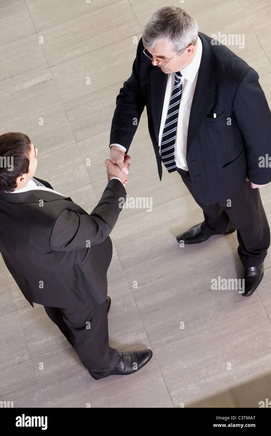 Above view of two managers shaking hands Stock Photo - Alamy