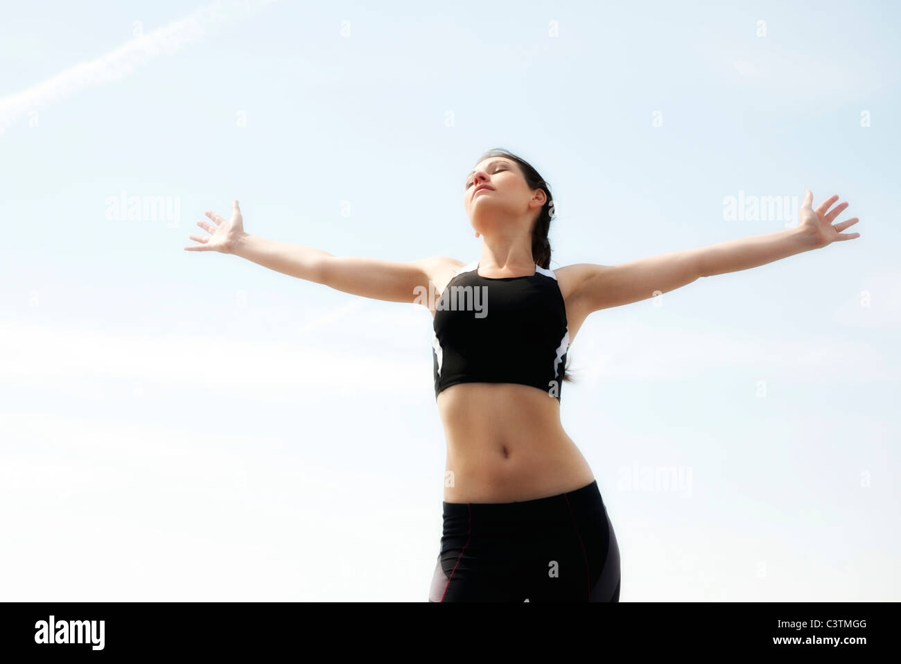 sportswoman stretching arms out Stock Photo - Alamy