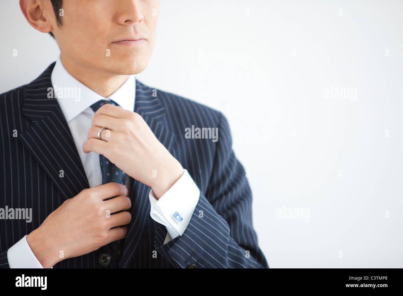 Man adjusting necktie hi-res stock photography and images - Alamy