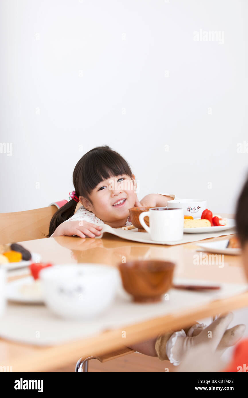 Girl at Dining Table Stock Photo - Alamy