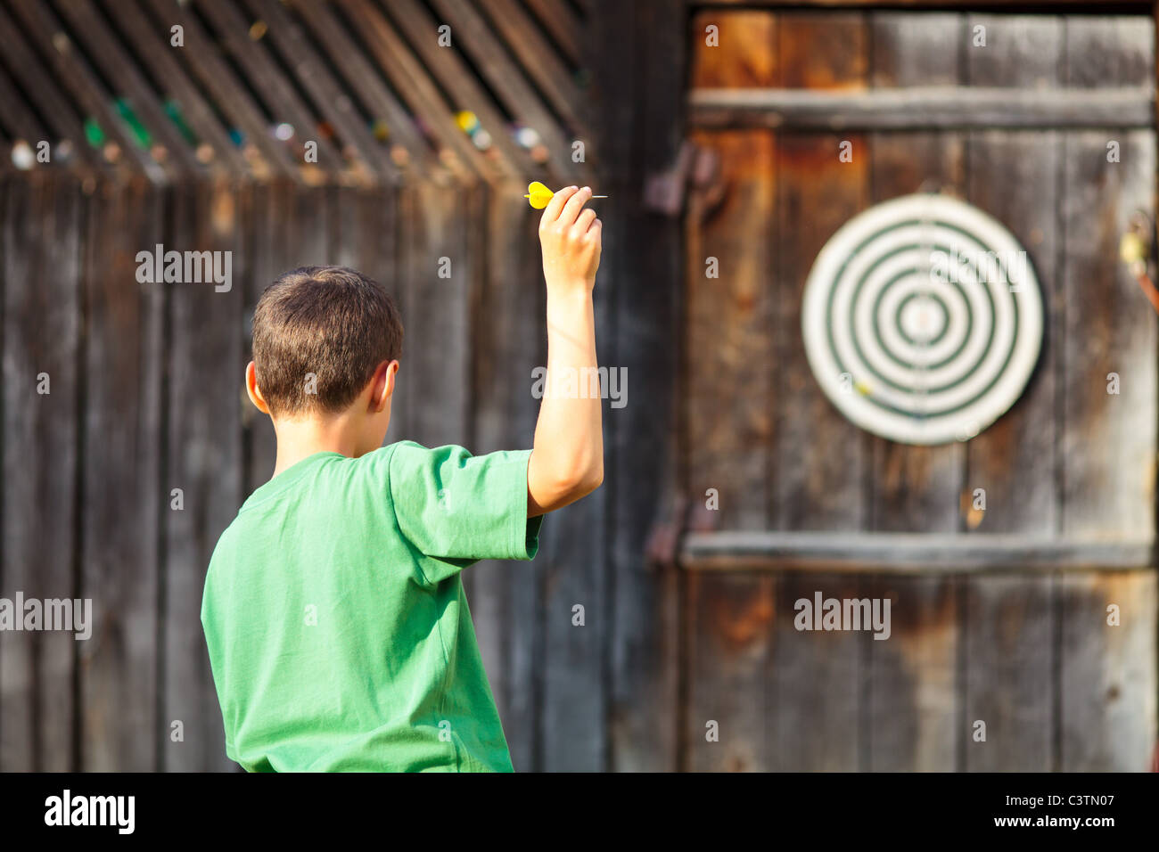 Playing darts child hi-res stock photography and images - Alamy