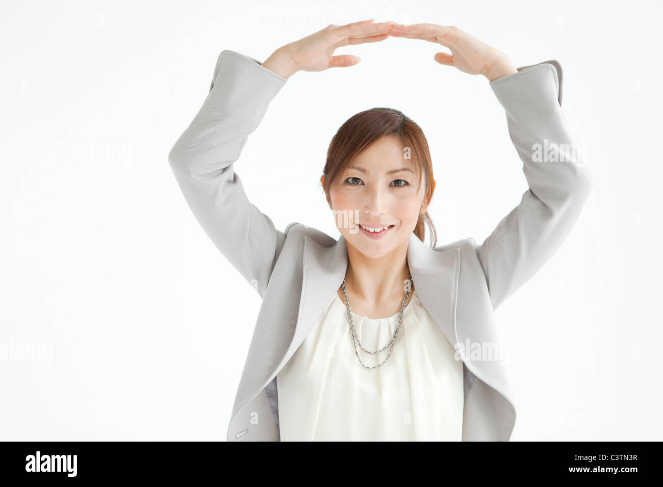 Businesswoman Holding Hands Above Head Stock Photo - Alamy