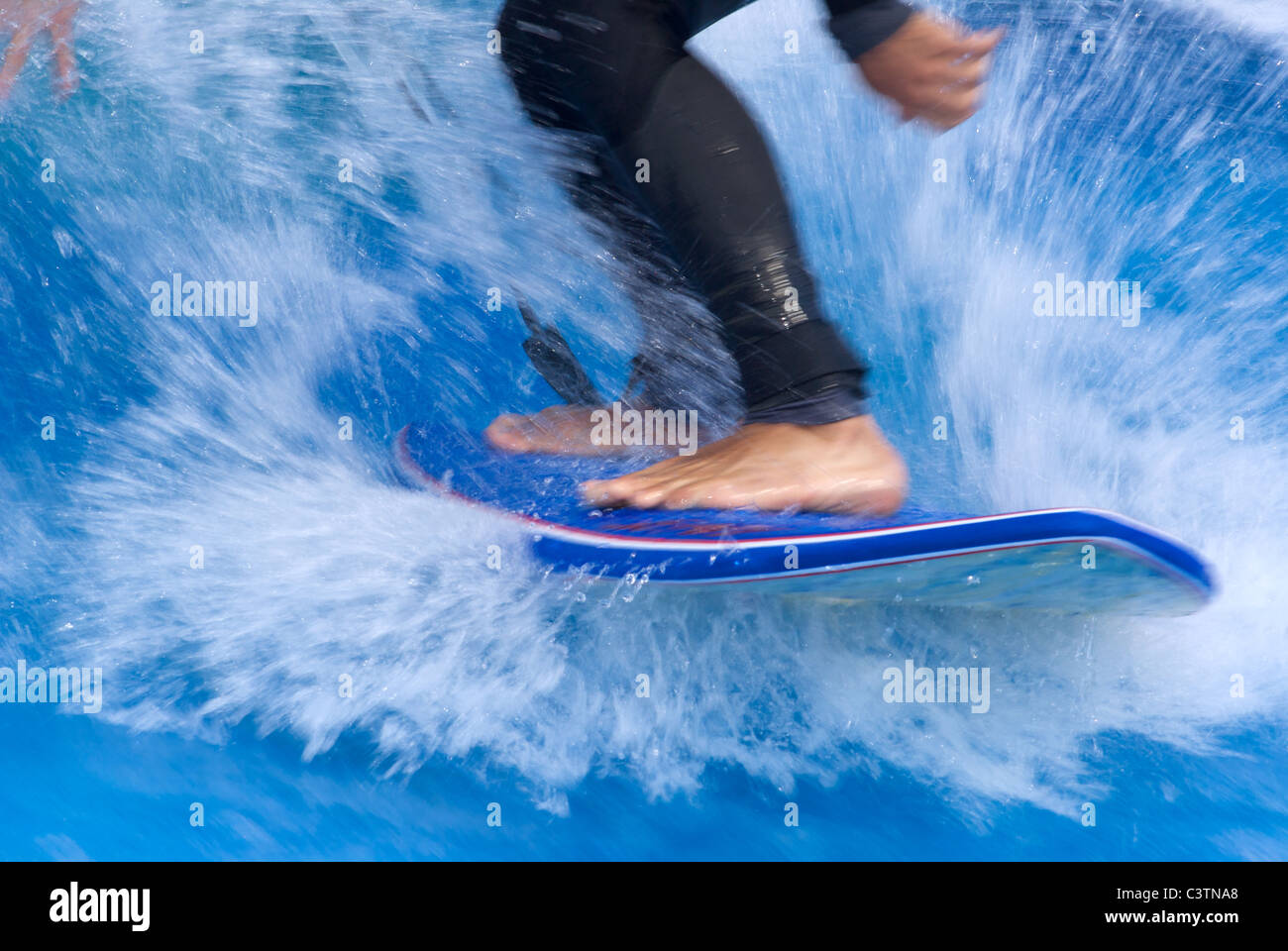 feets on a surfboard in the wave, close up Stock Photo - Alamy