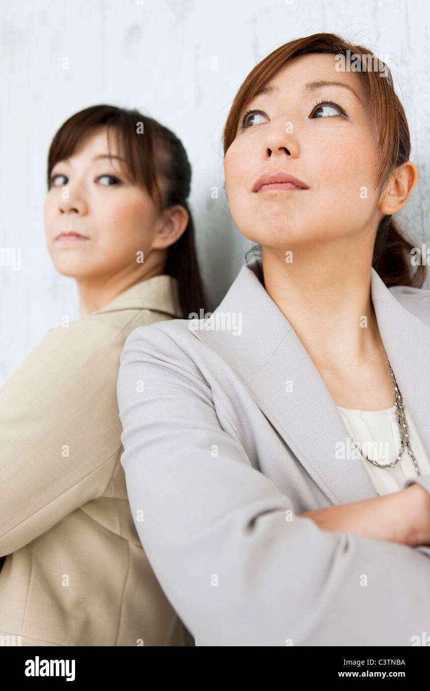 Two Businesswomen Back To Back Stock Photo - Alamy