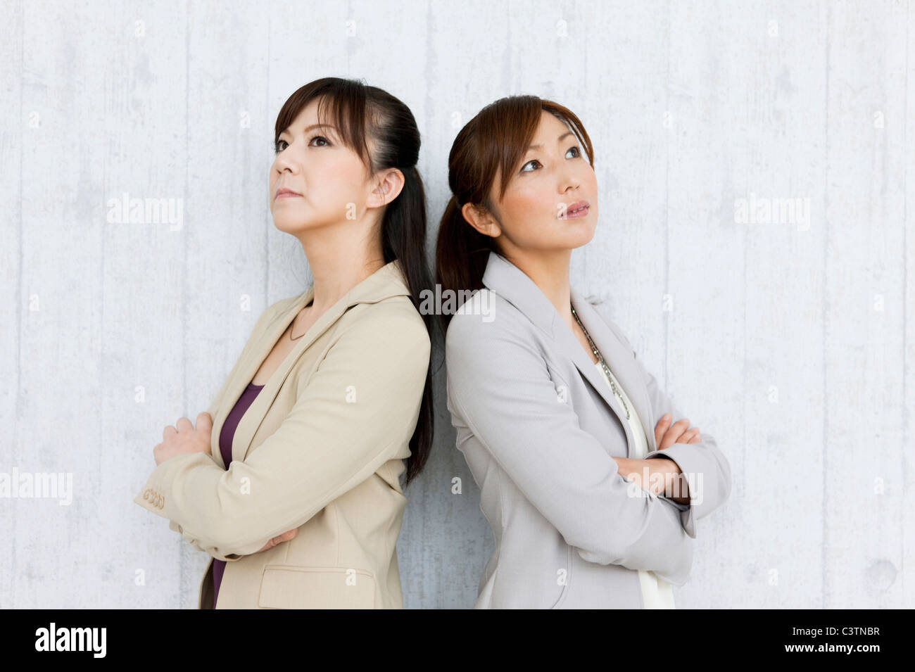 Two Businesswomen Back To Back Stock Photo - Alamy