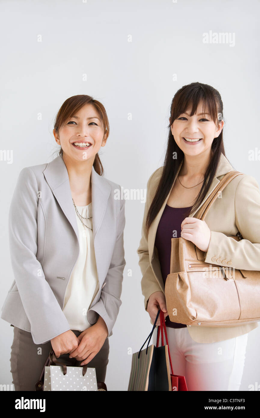 Two Women With Shopping Bags Stock Photo - Alamy