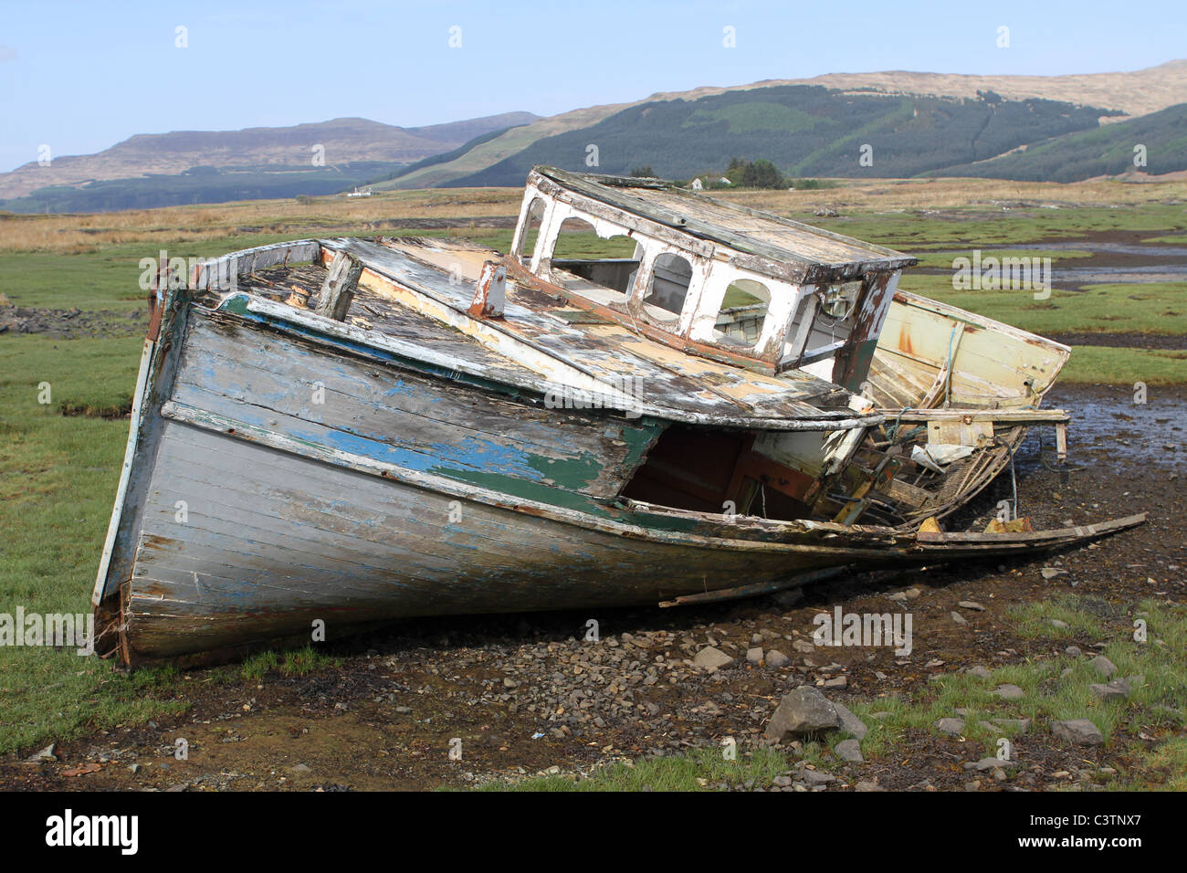 Shipwrecked boat on the shoreline left to rot in Isle of Mull Inner ...
