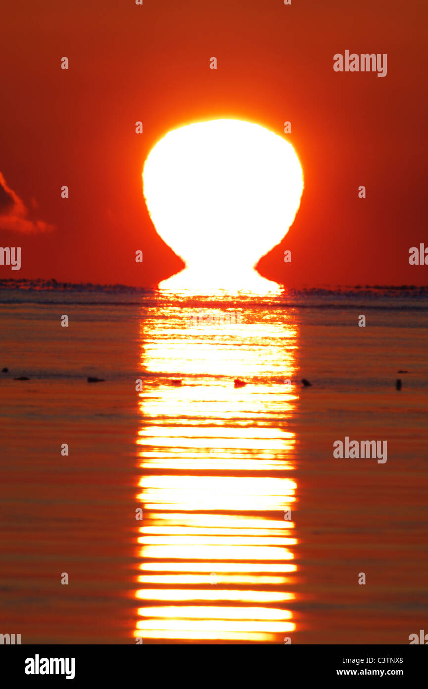 Rising sun over sea in hi-res stock photography and images - Alamy