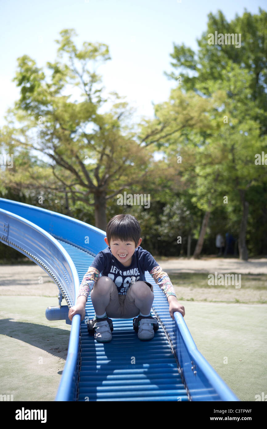 Boy on Slide Stock Photo - Alamy