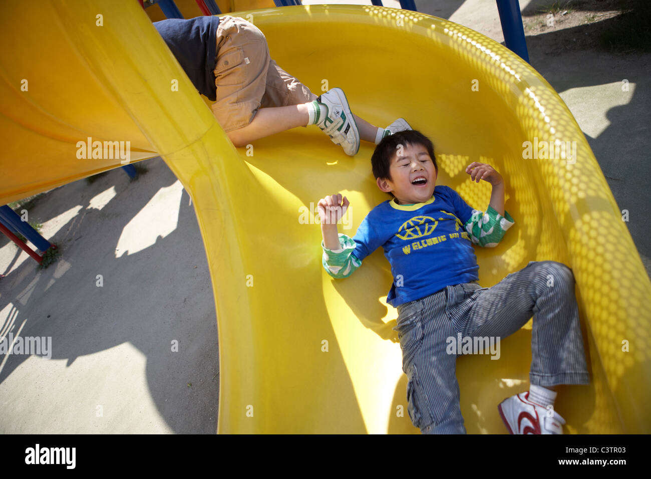 Boy on Slide Stock Photo - Alamy