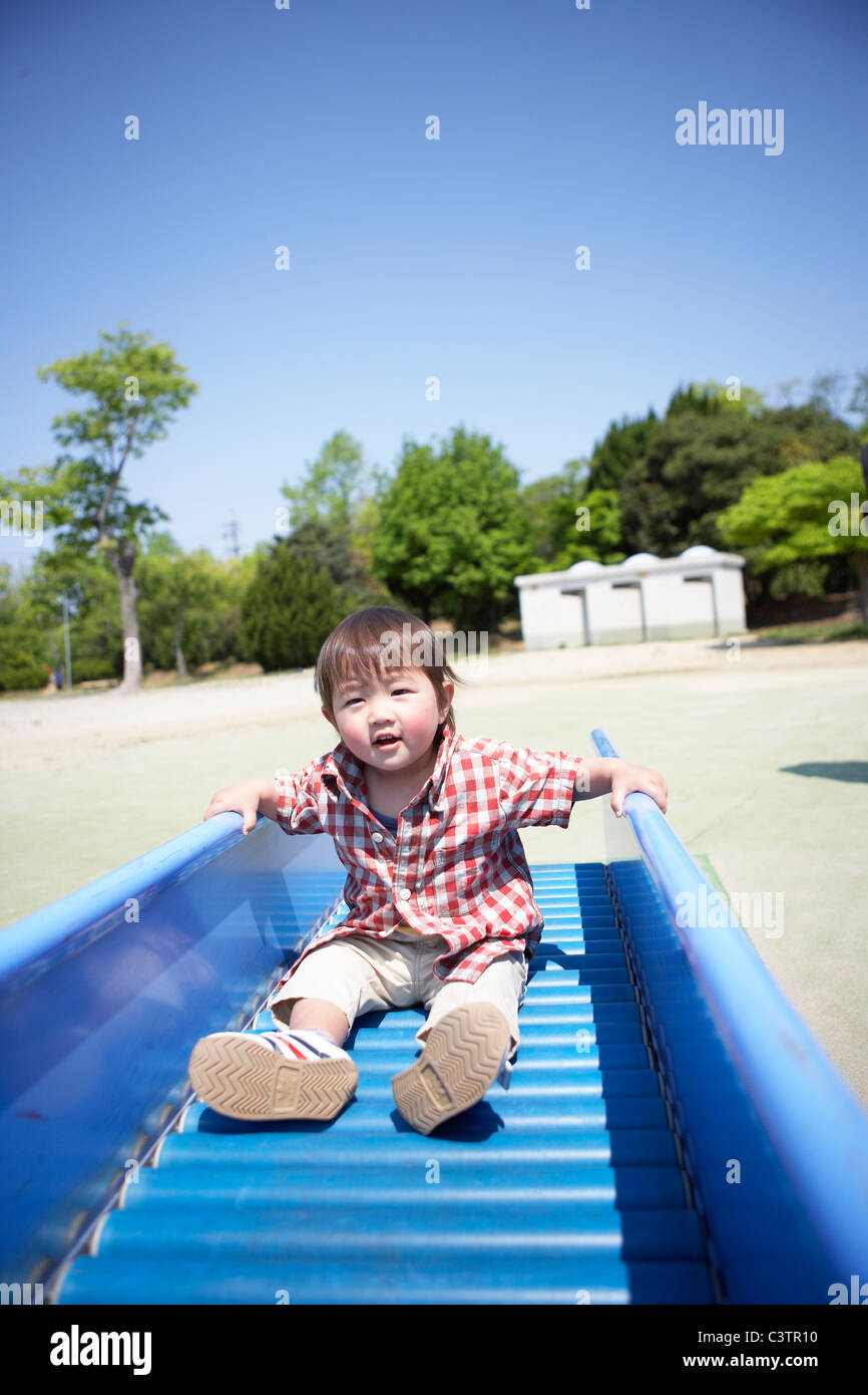 Baby Boy on Slide Stock Photo - Alamy
