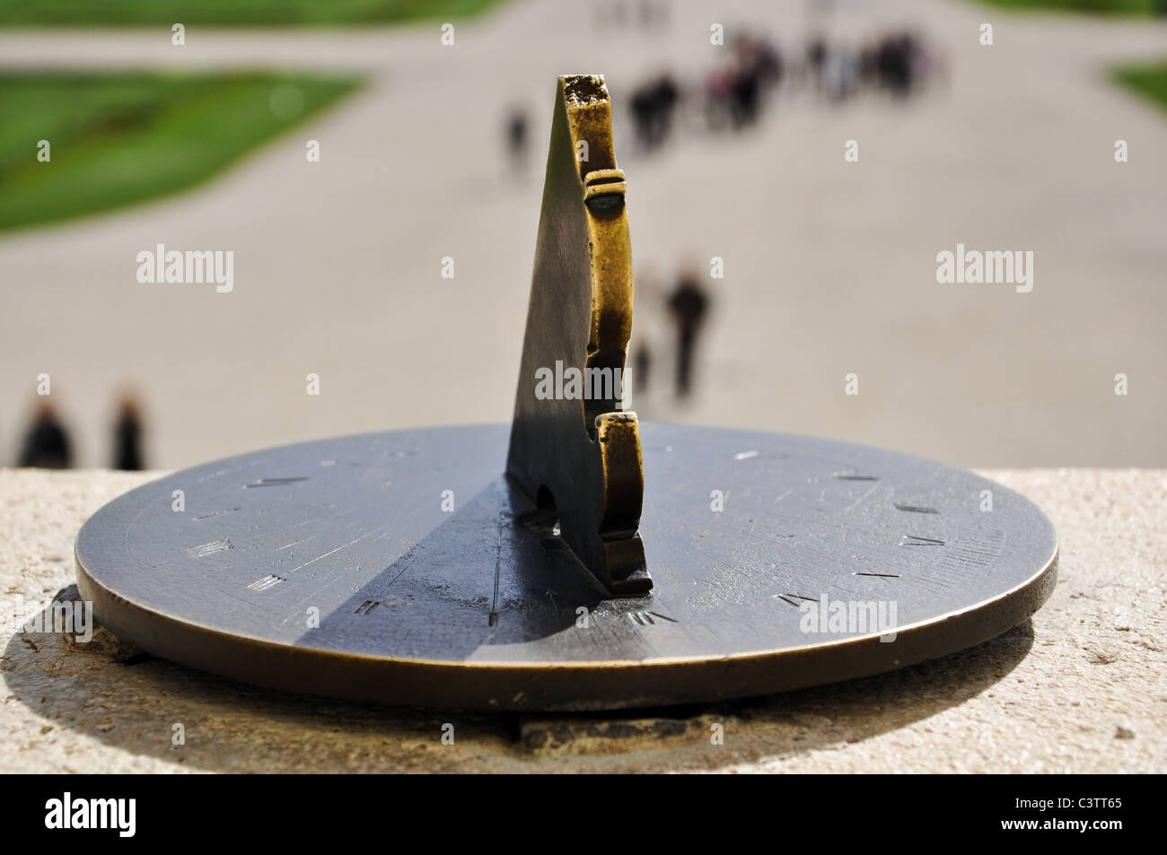 closeup of an antique copper sundial in front of a garden Stock Photo ...