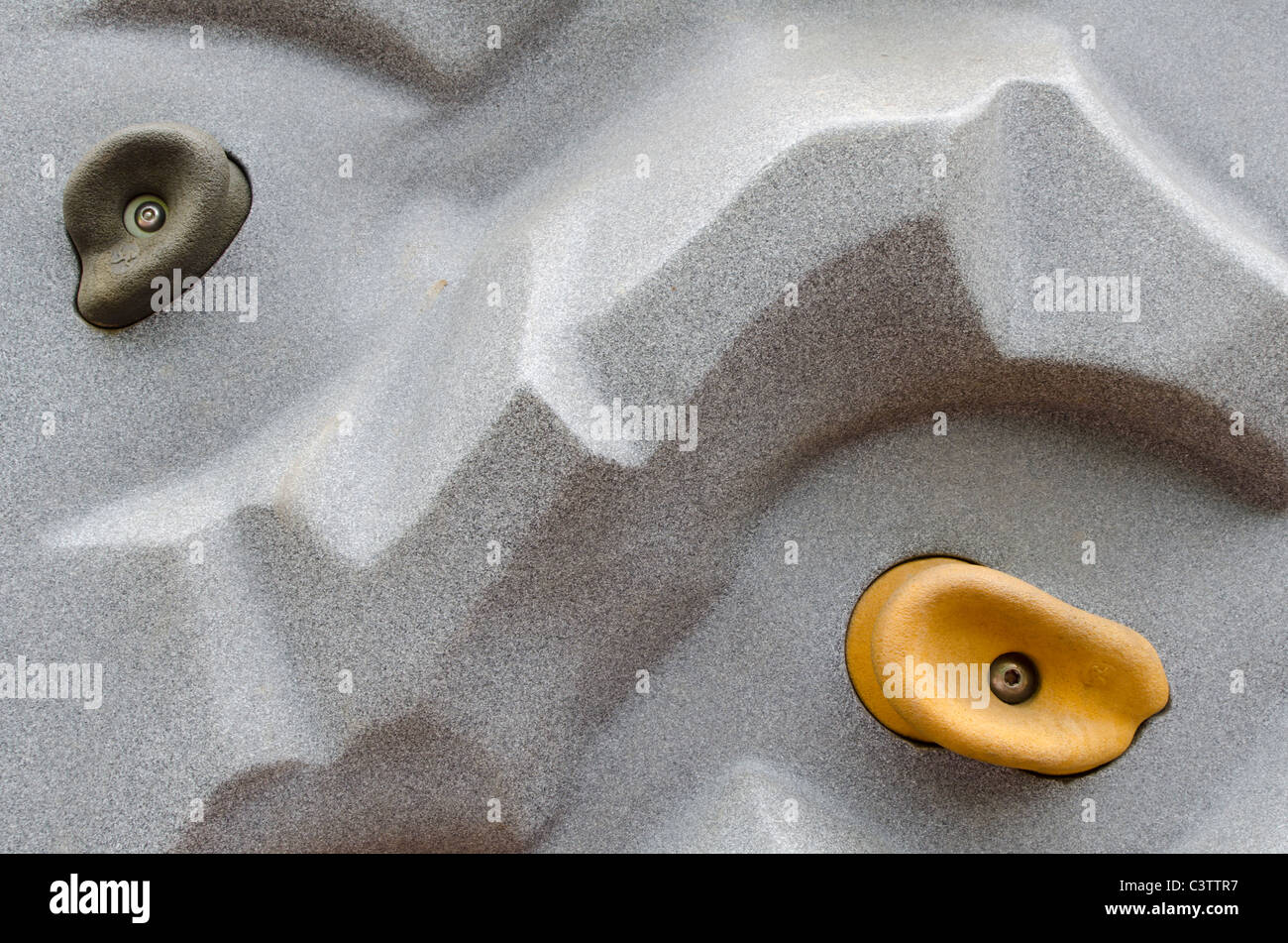 Hand grips on climbing wall Stock Photo - Alamy