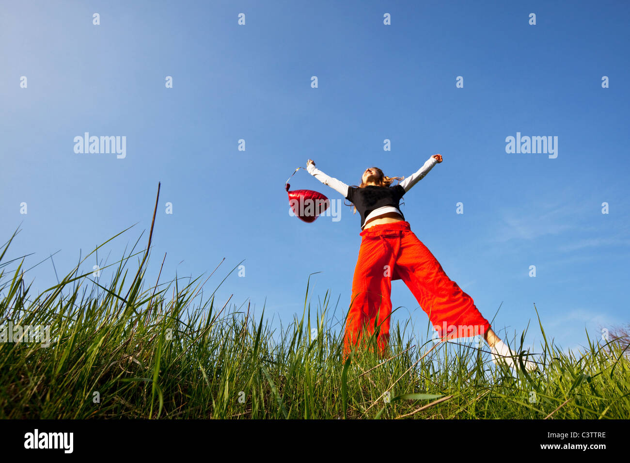 Happy girl on grassland Stock Photo - Alamy