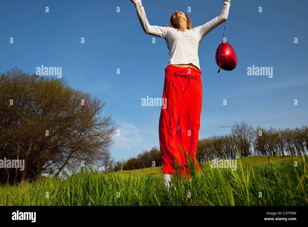 Happy girl on grassland Stock Photo - Alamy