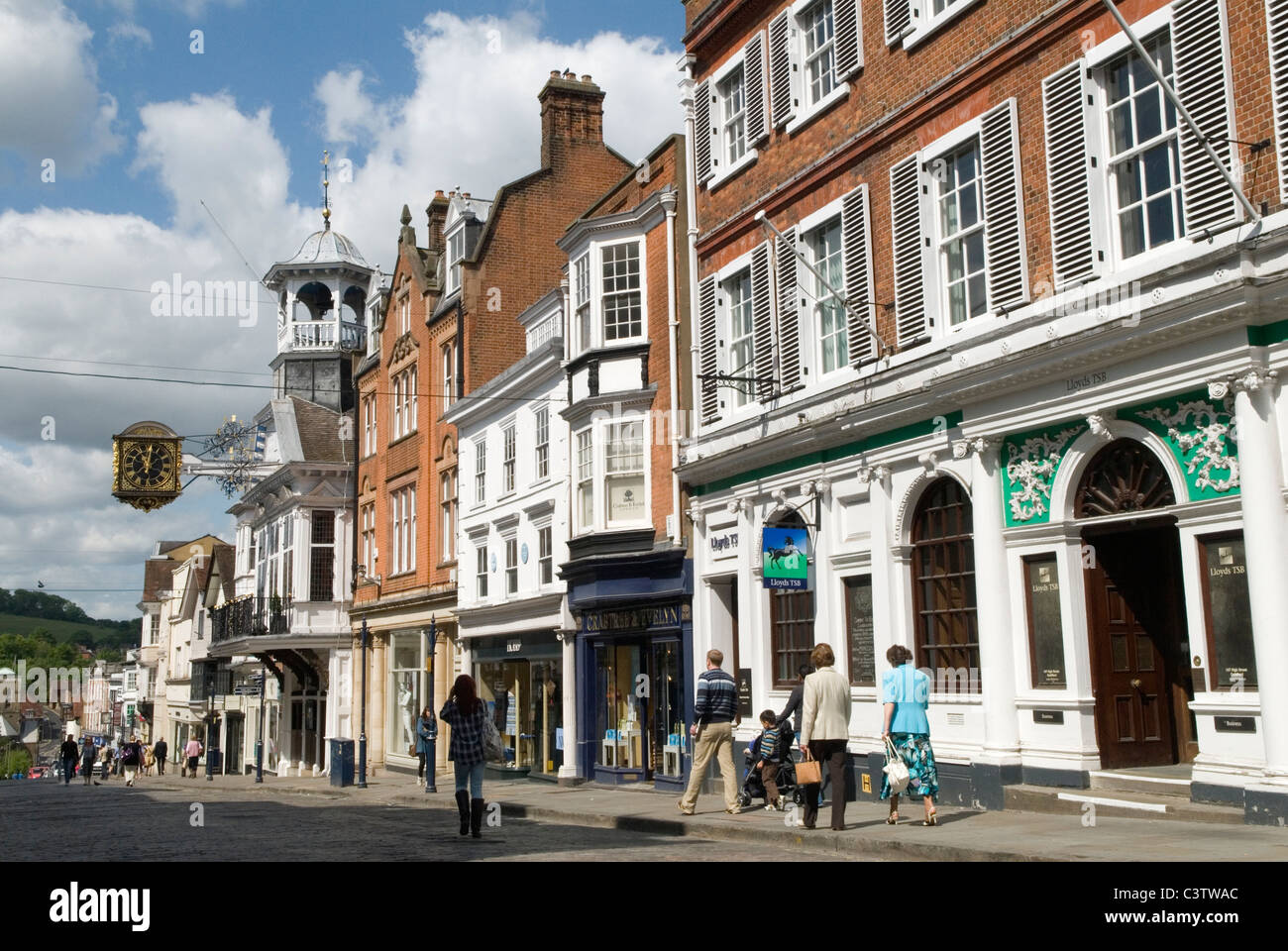Guildford Surrey UK. High Street shoppers. The Guildhall with ornate ...