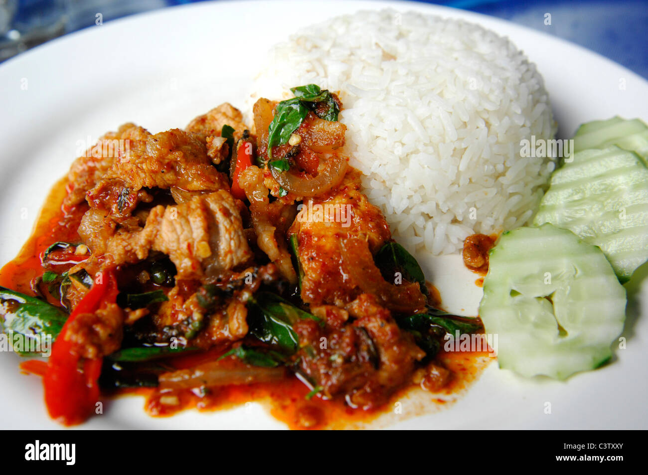 rice served with stir fired pork with red curry paste, thai street food ...