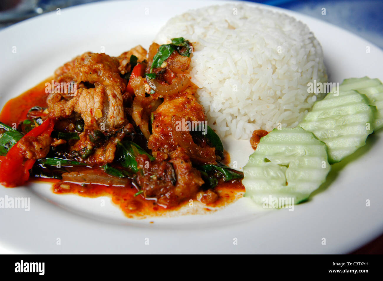 rice served with stir fired pork with red curry paste, thai street food ...