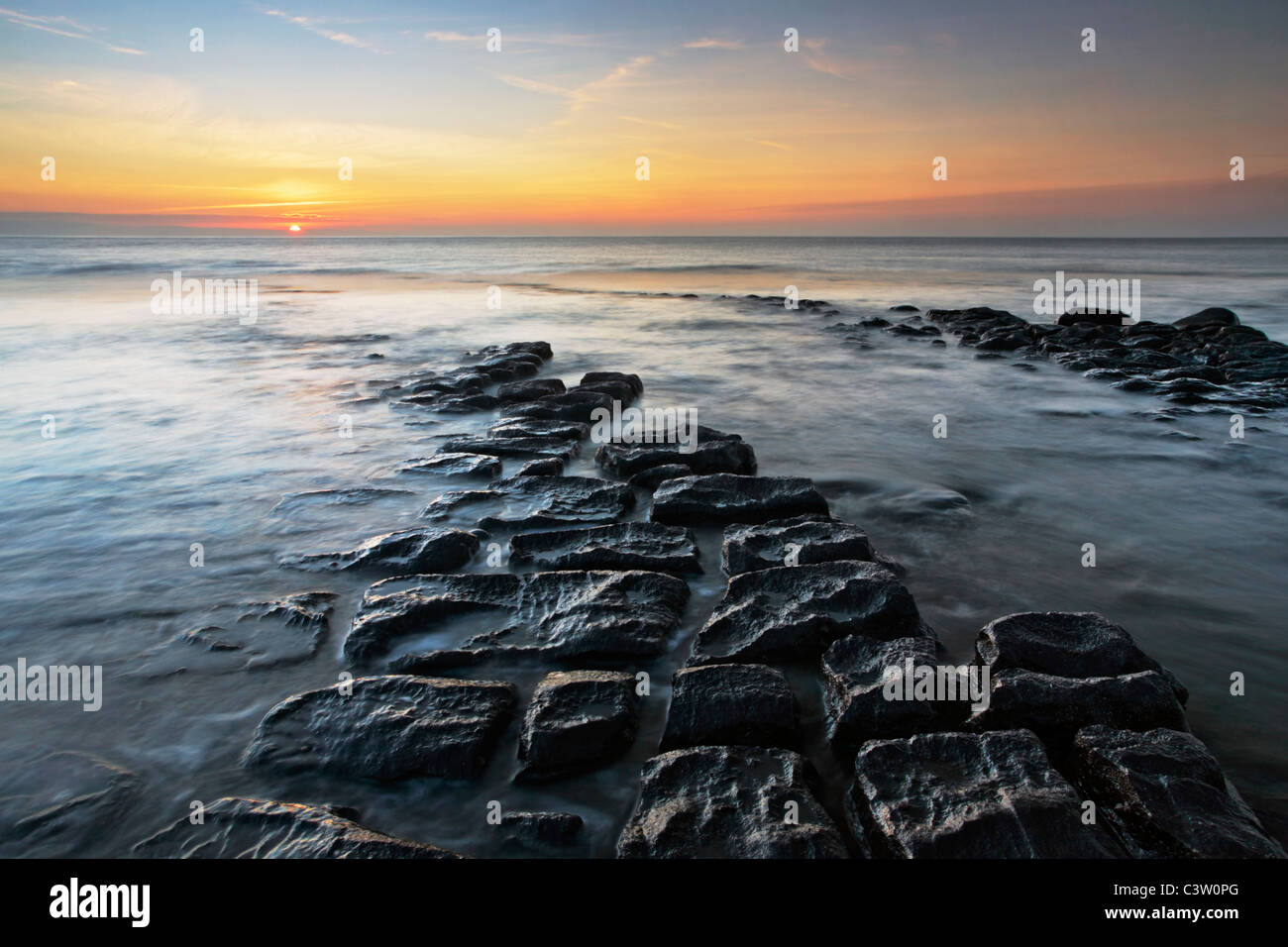 Sunset over the Bristol Channel as seen from the dramatic rocky shores ...