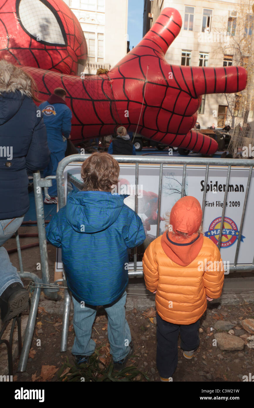 Two young boys watching the inflation of the Spiderman balloon the day ...