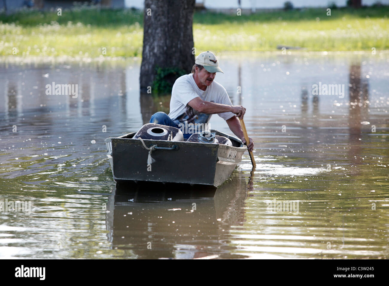 Bill Sandquist paddles past his home in the Red Star District of Cape ...