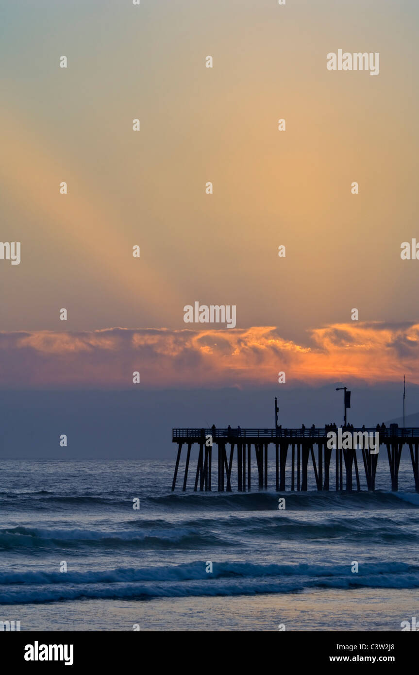 Sunset light over the pier and ocean waves at Pismo Beach, San Luis ...