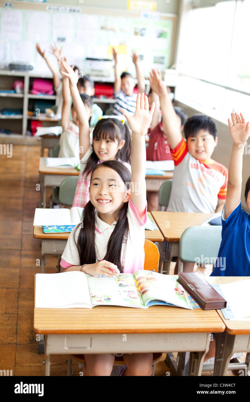 Schoolchildren Raising Hands in Classroom Stock Photo - Alamy Schoolchildren Raising Hands in Classroom Stock Photo - Alamy