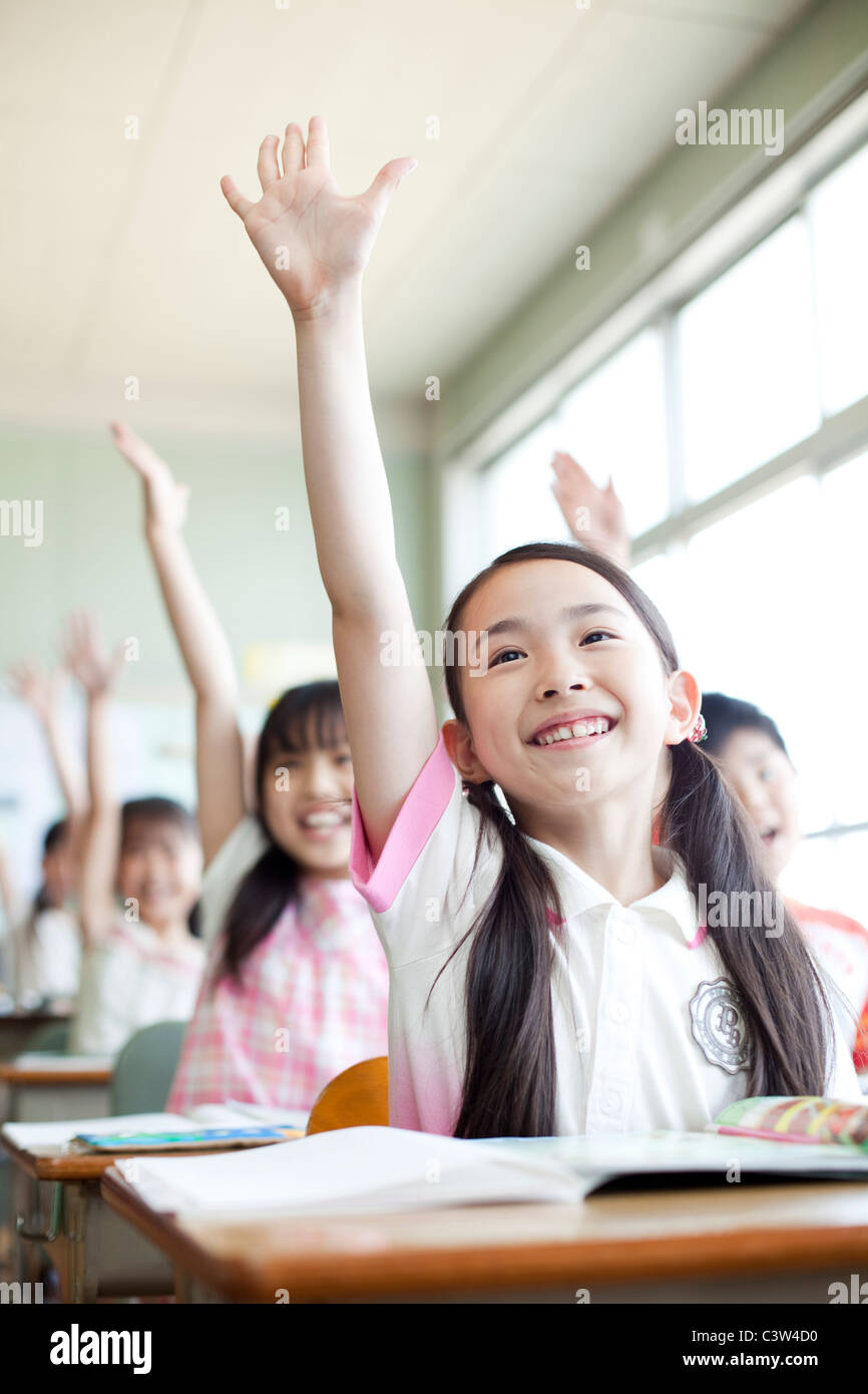 Schoolchildren Raising Hands in Classroom Stock Photo - Alamy Schoolchildren Raising Hands in Classroom Stock Photo - Alamy