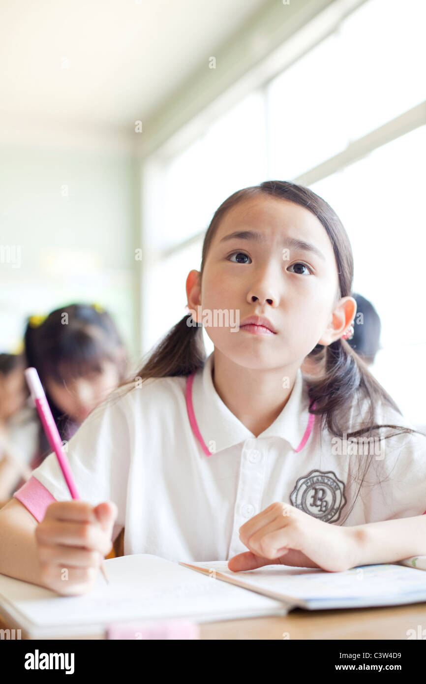 Girl Concentrating in Classroom Stock Photo - Alamy