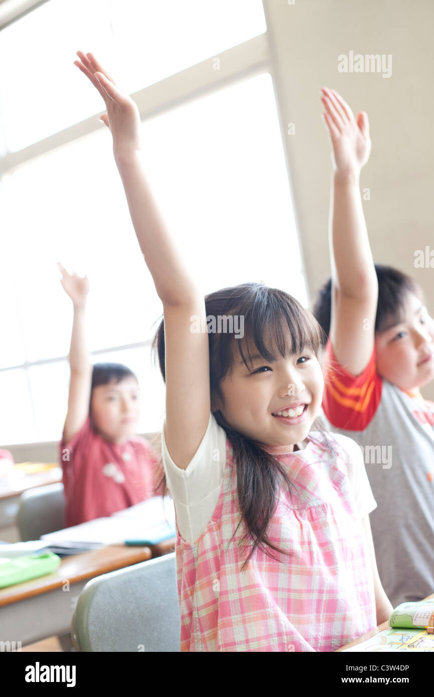 Schoolchildren Raising Hands Stock Photo - Alamy