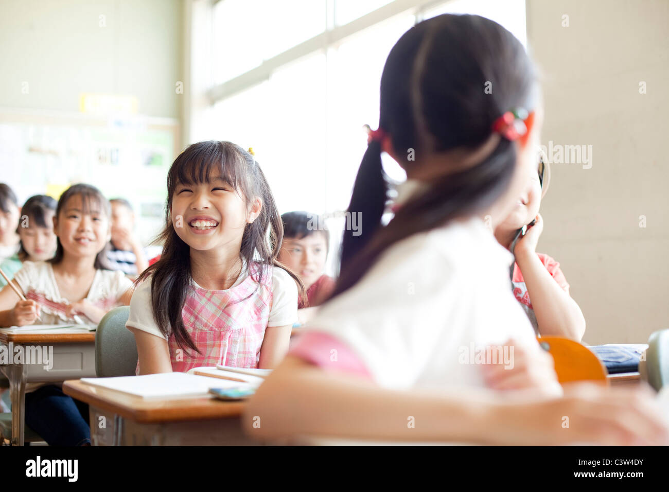 Schoolgirl Laughing in Classroom Stock Photo - Alamy