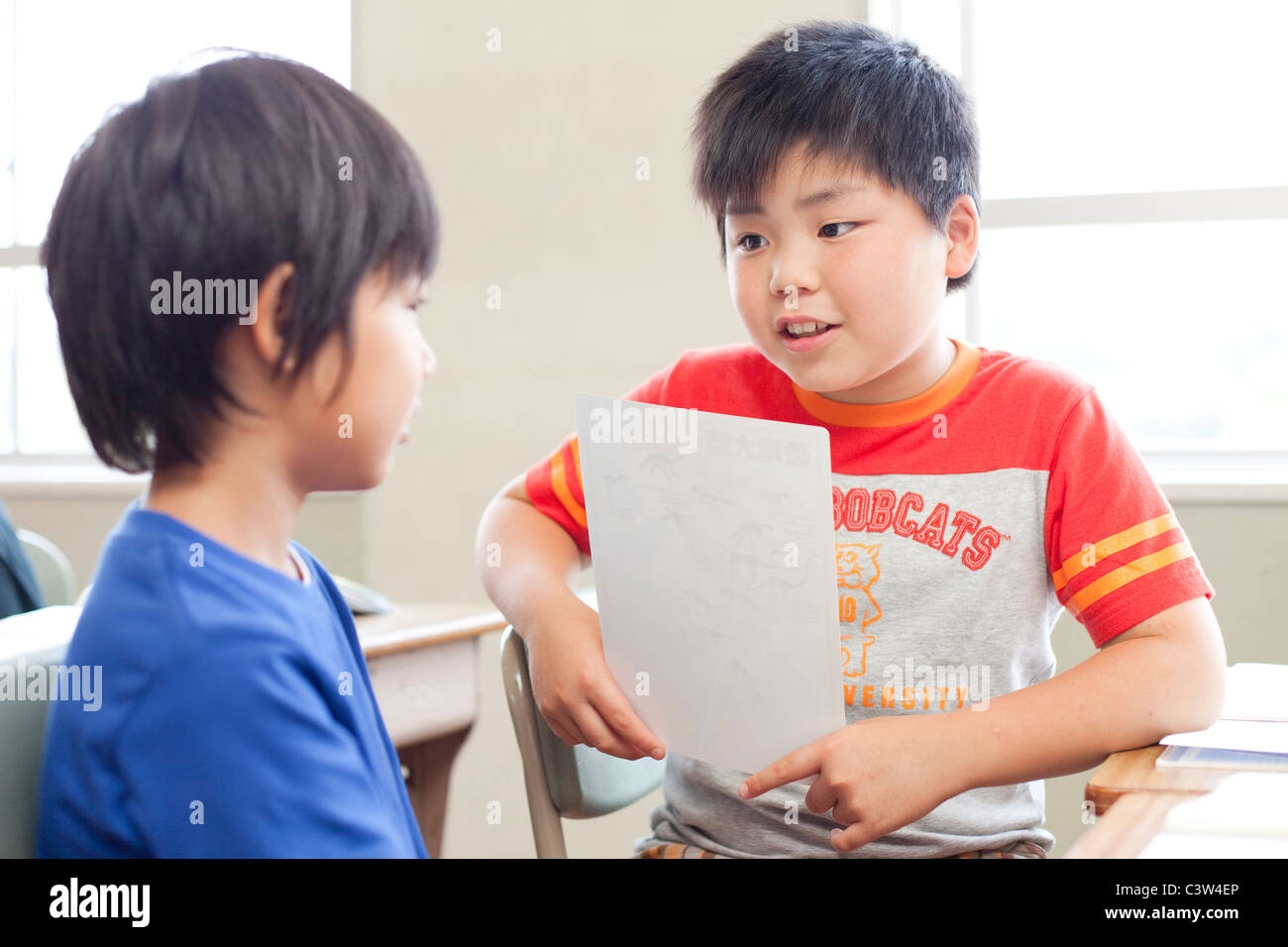Two boys talking classroom hi-res stock photography and images - Alamy